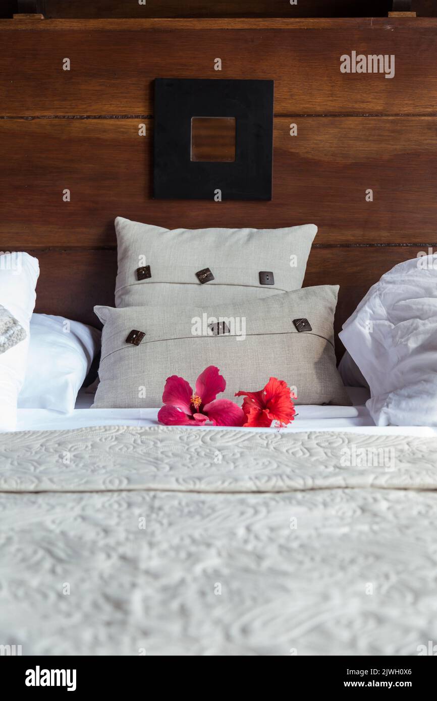 Large bed with flowers in a luxury hotel room. Very cozy atmosphere ...