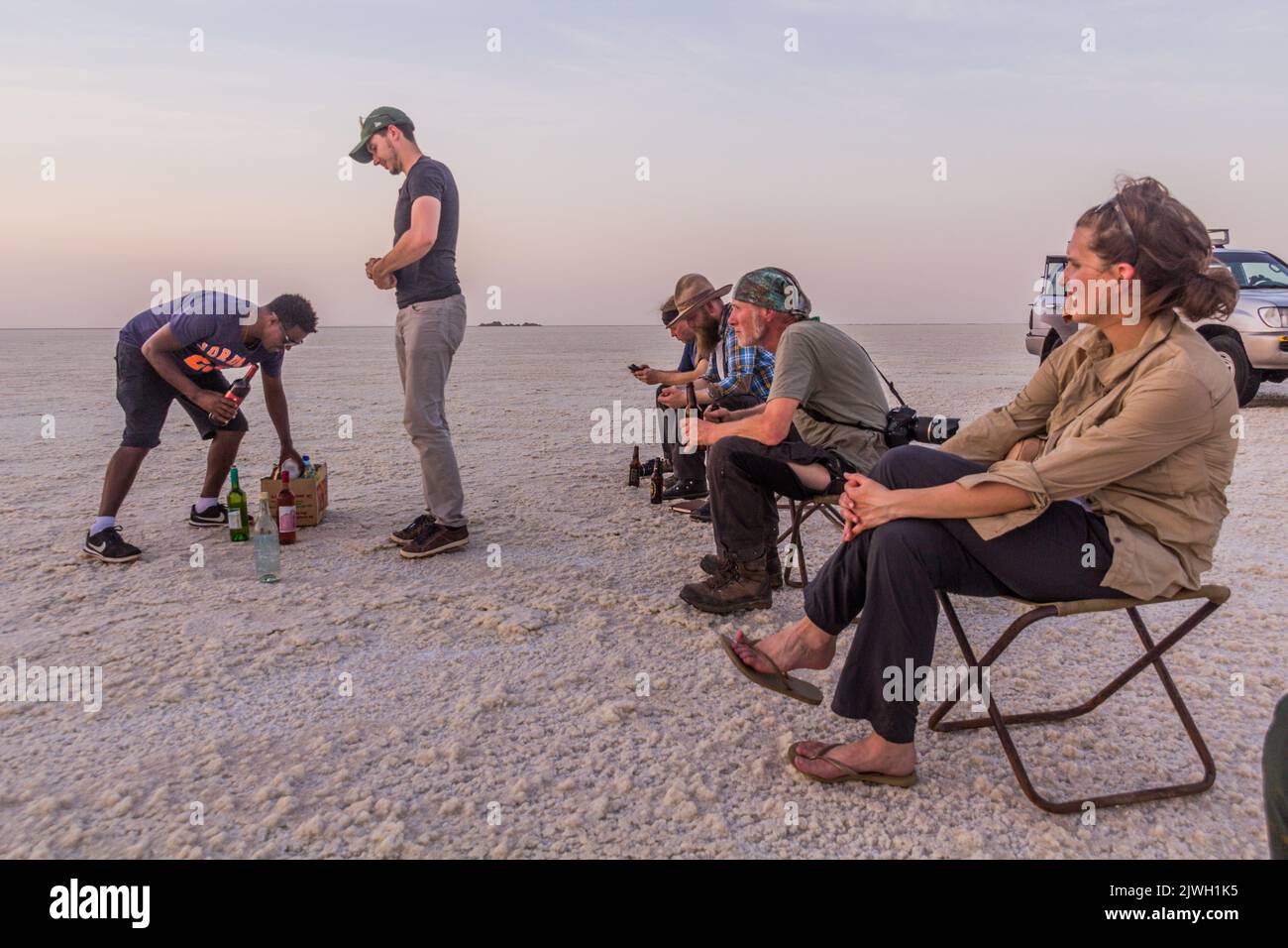 DANAKIL, ETHIOPIA - MARCH 24, 2019: Tourists enjoying evening at the ...