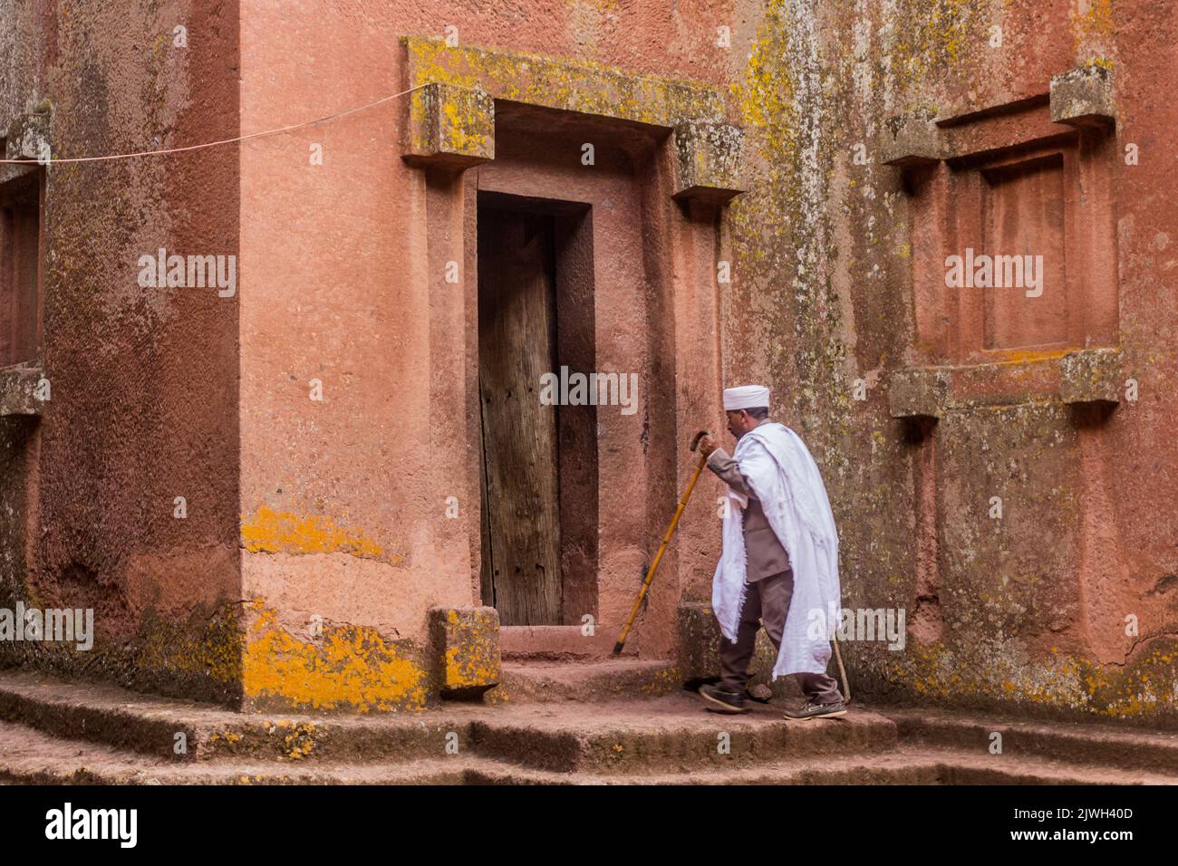 LALIBELA, ETHIOPIA - MARCH 29, 2019: Local man walking in the Saint ...