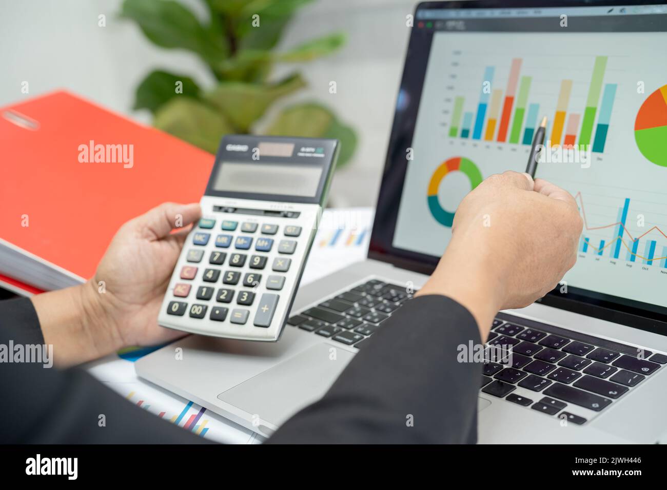 Asian accountant working and analyzing financial reports project ...