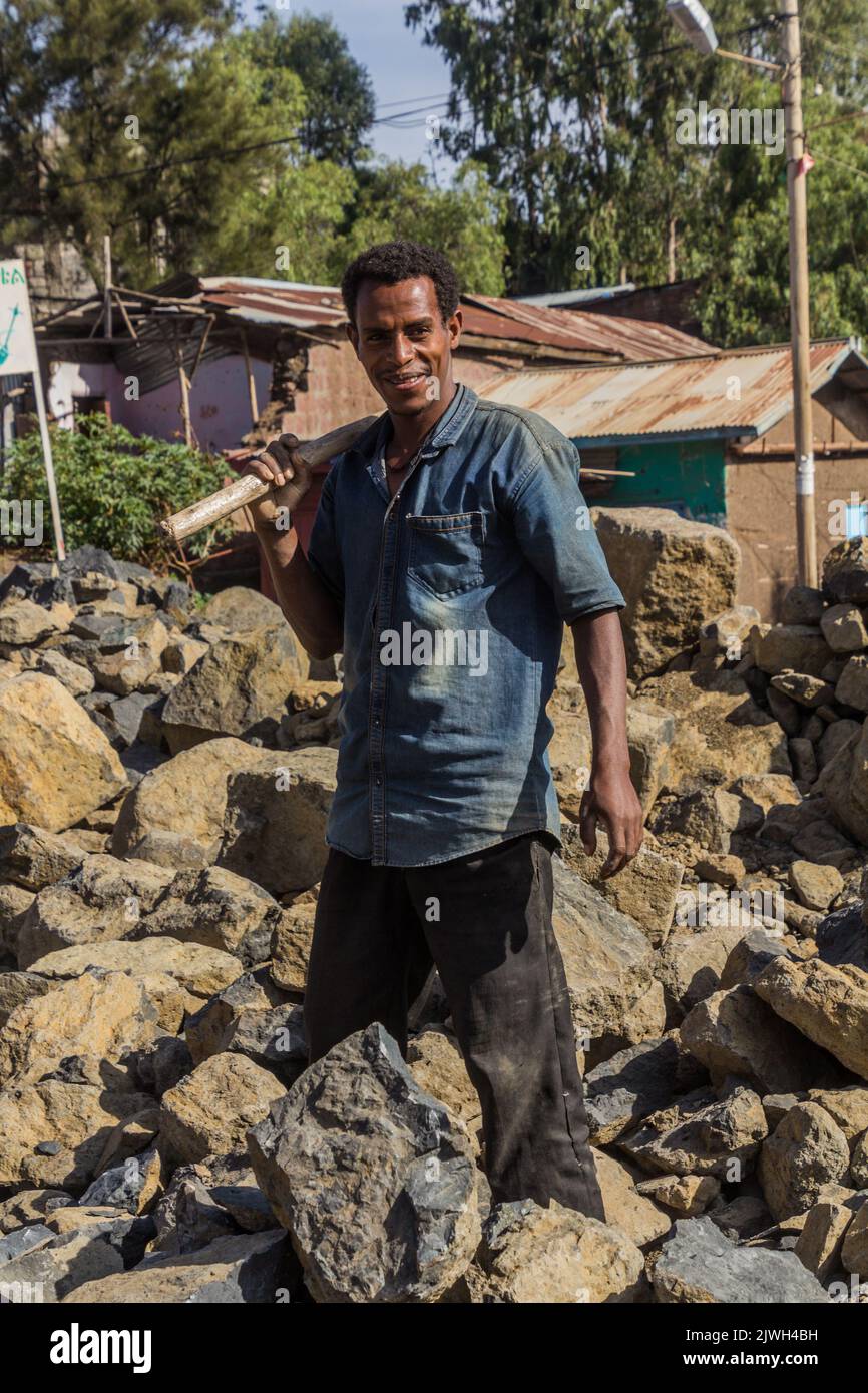 LALIBELA, ETHIOPIA - MARCH 29, 2019: Local worker breaking rocks on a ...