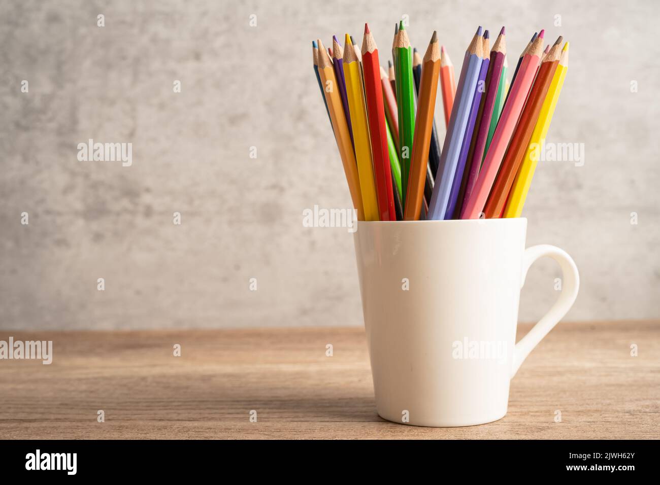 Colorful pencils in white cup with copy space, learning university ...