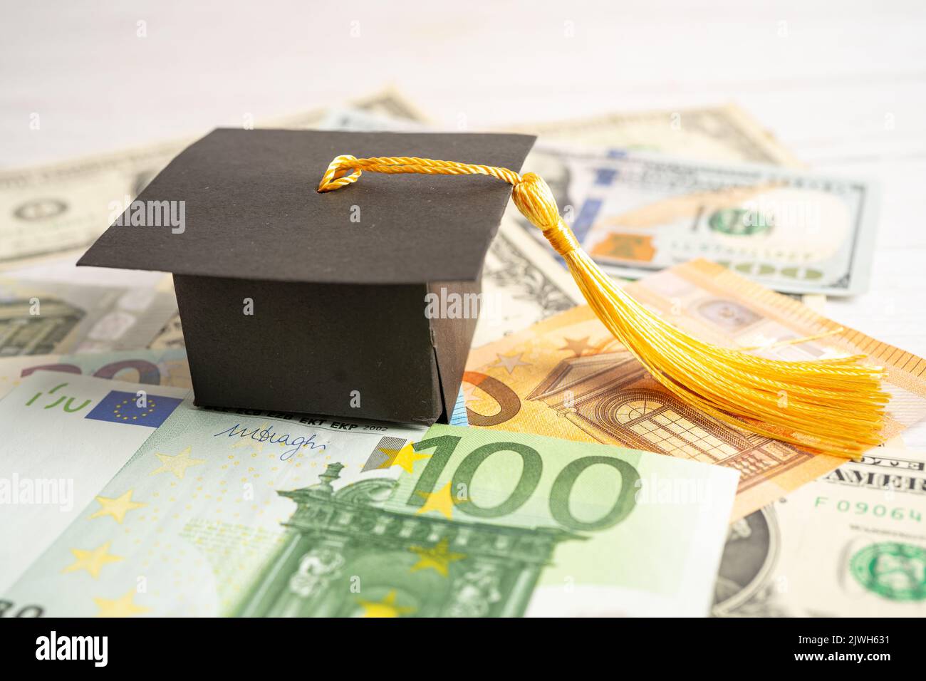 Graduation gap hat on US dollar and EURO banknotes money, Education ...