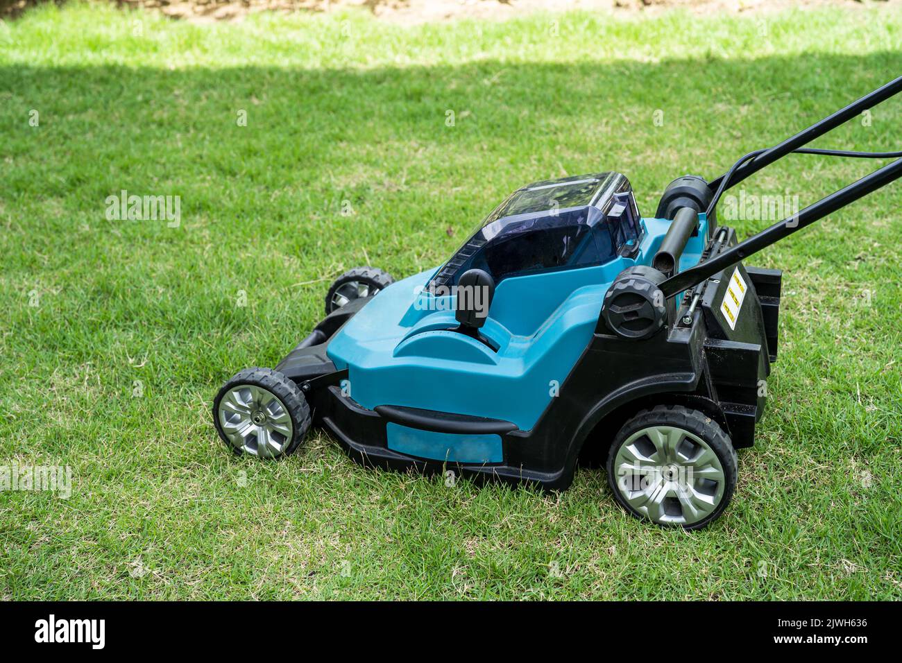 Lawn mover machine cut green grass, Hobby planting home garden Stock ...