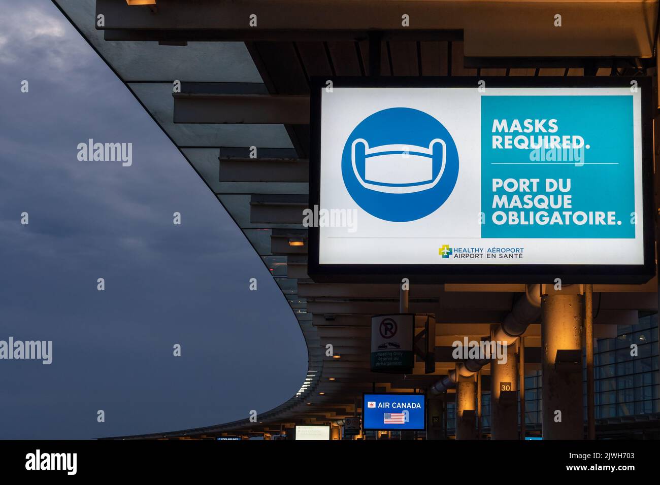 Masks Required warning sign at passenger drop-offs curbside in Toronto ...