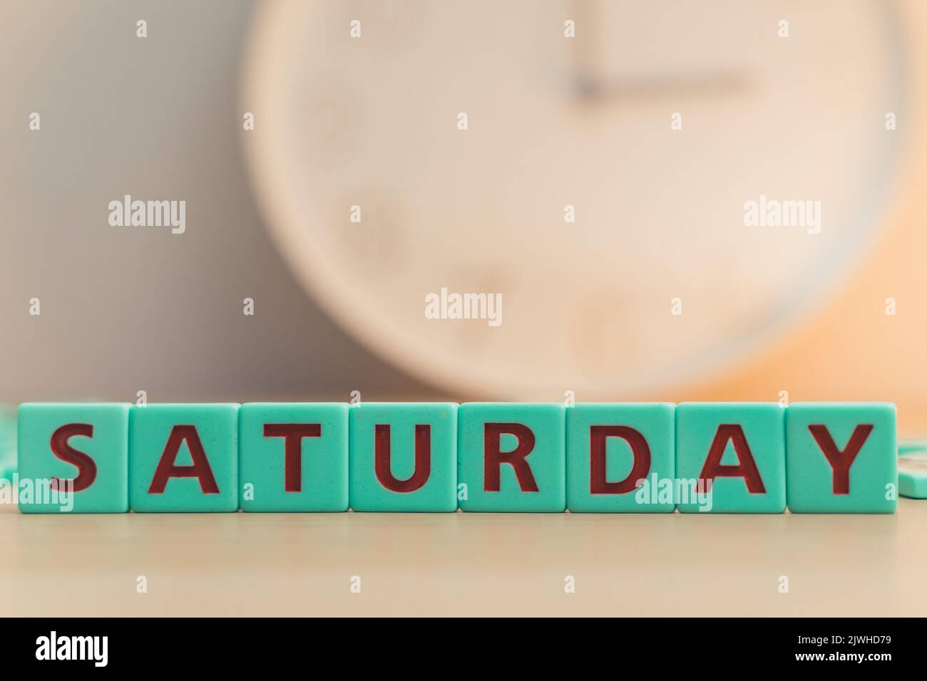 The word SATURDAY made of square colorful letters on the table with a ...