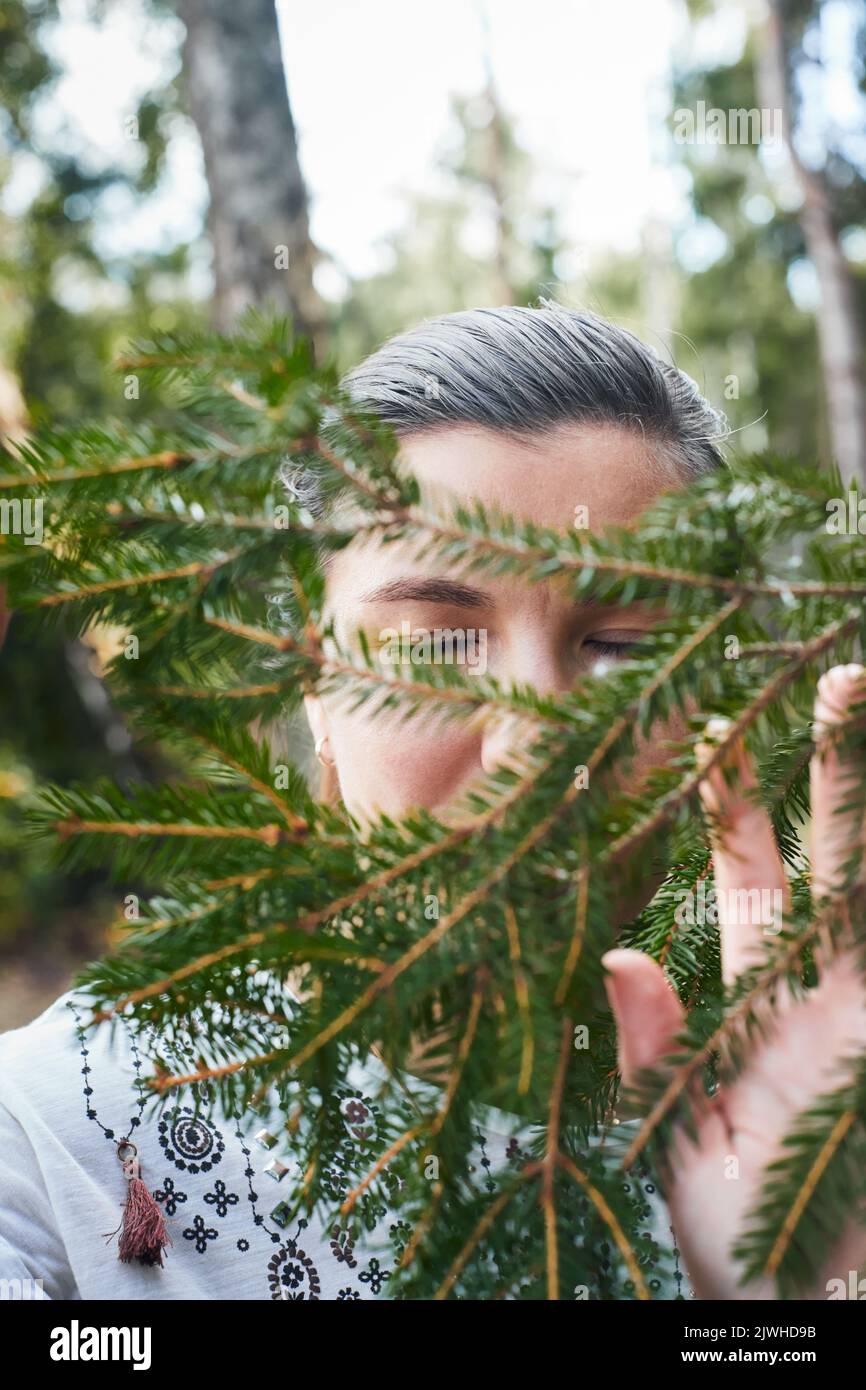A woman embraces a coniferous tree in the forest. The concept of living ...