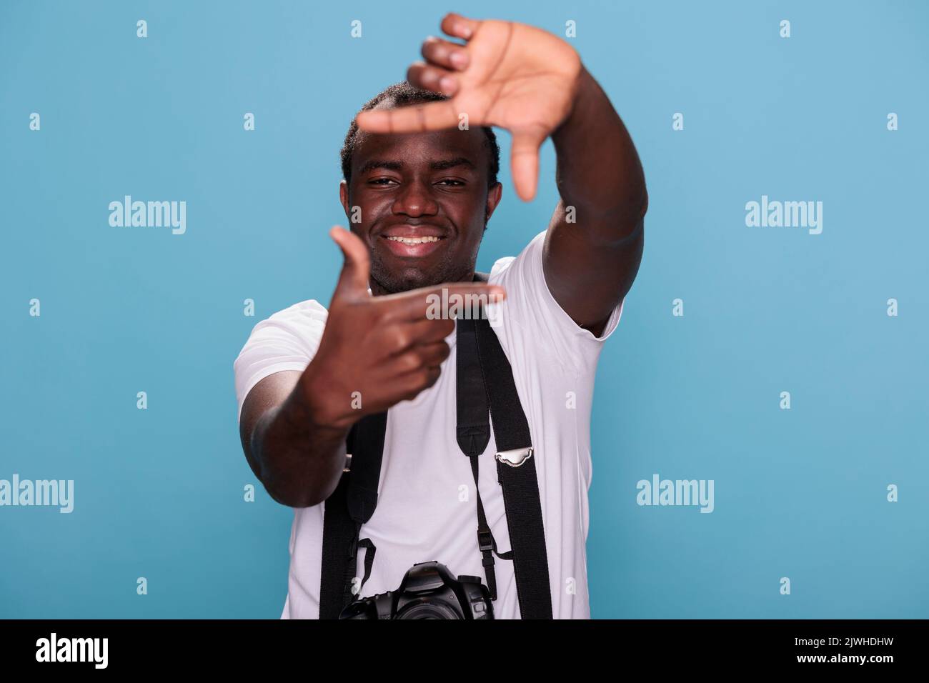 Photography enthusiast with photo device gesturing picture taking with ...