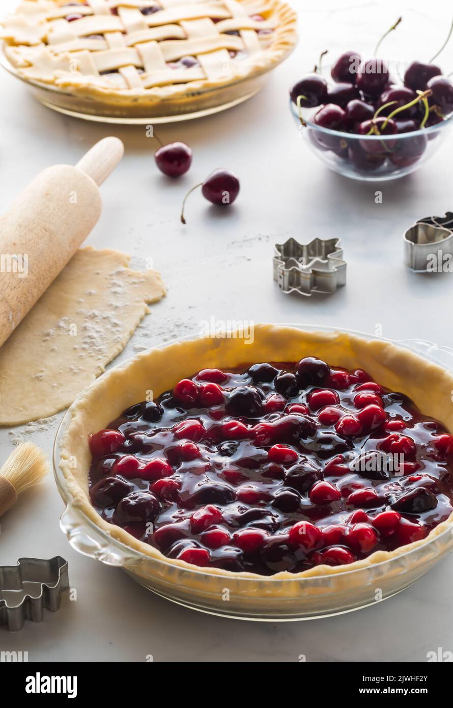 Preparing cherry pies for baking, against a bright sunny window Stock ...