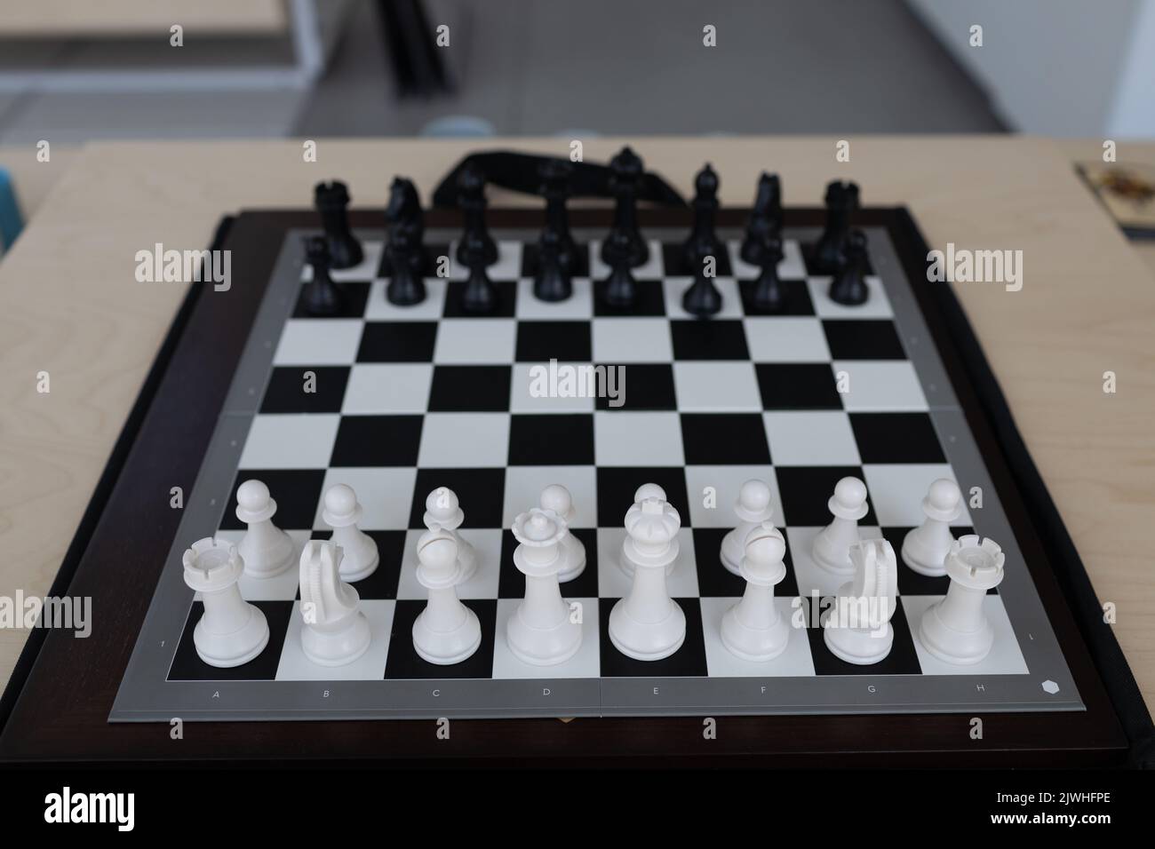 New chess board with chess pieces on table for game Stock Photo - Alamy
