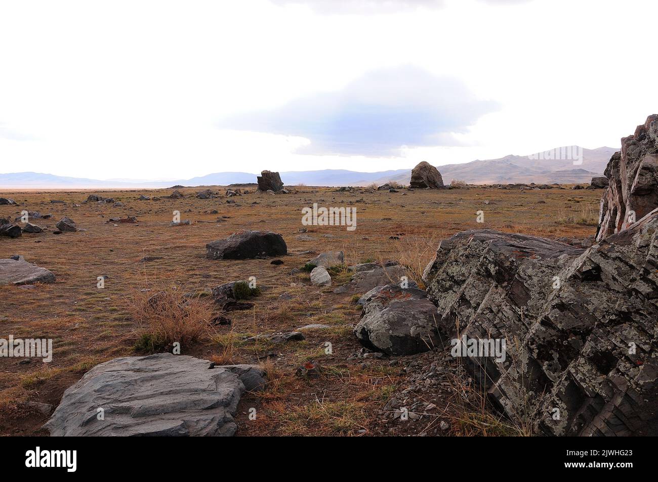 The ruins of an ancient stone sanctuary in a flat and endless autumn ...