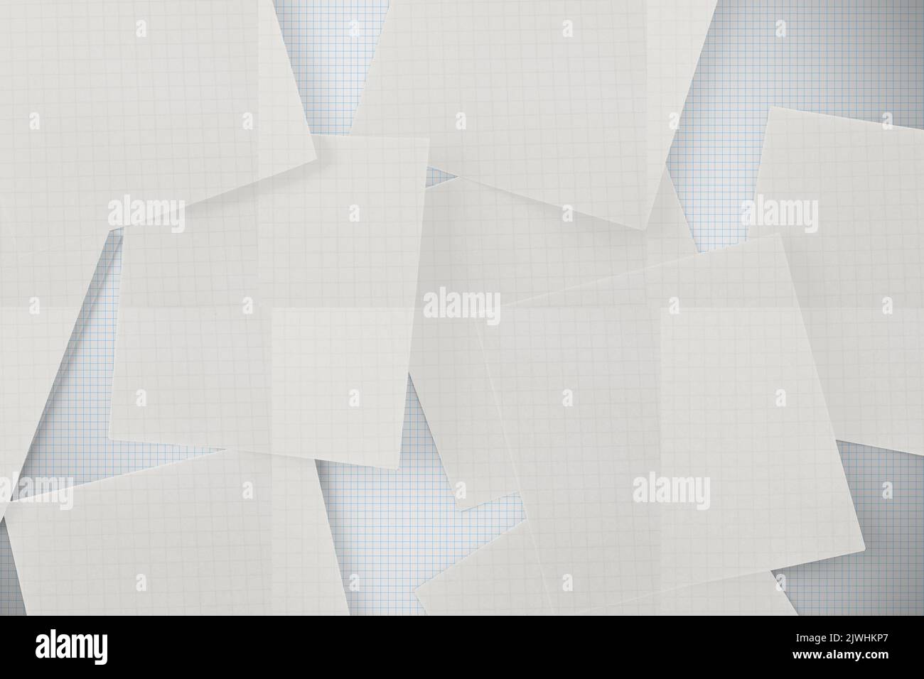 White paper strewn over grid paper Stock Photo - Alamy