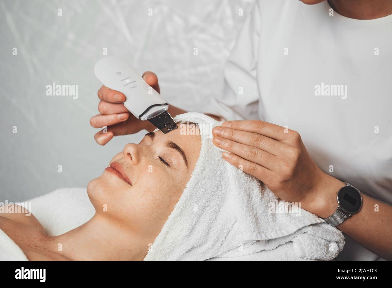 Close-up of beautiful woman's face during ultrasonic peel skin ...