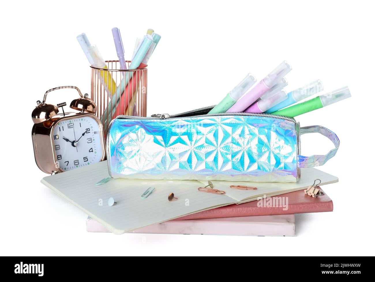 Holographic pencil case with school stationery and alarm clock on white ...