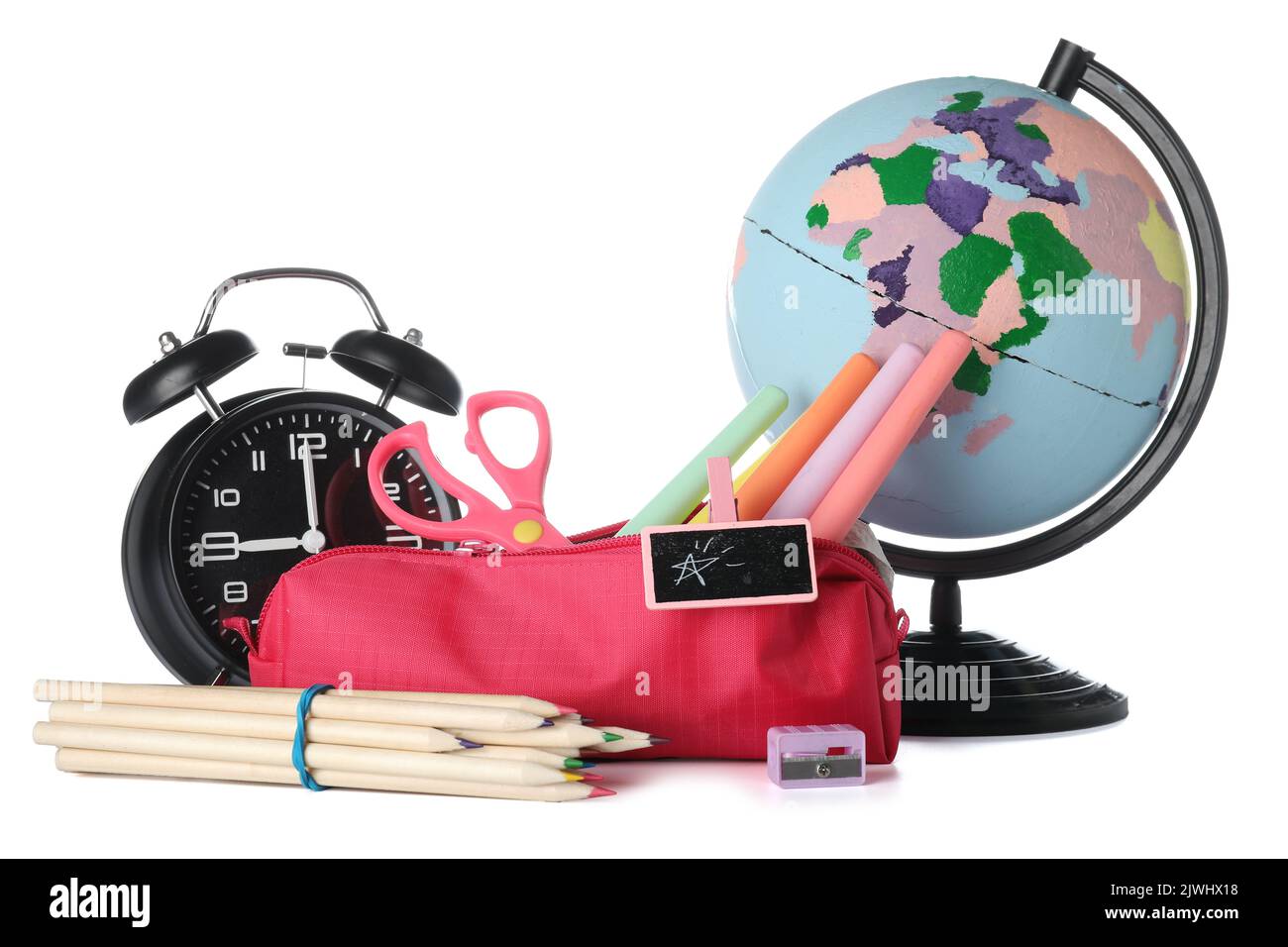 Pink pencil case with school stationery and alarm clock on white ...