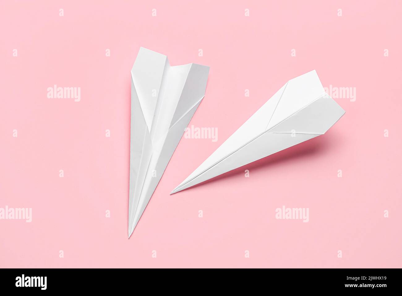 Paper planes on pink background Stock Photo - Alamy