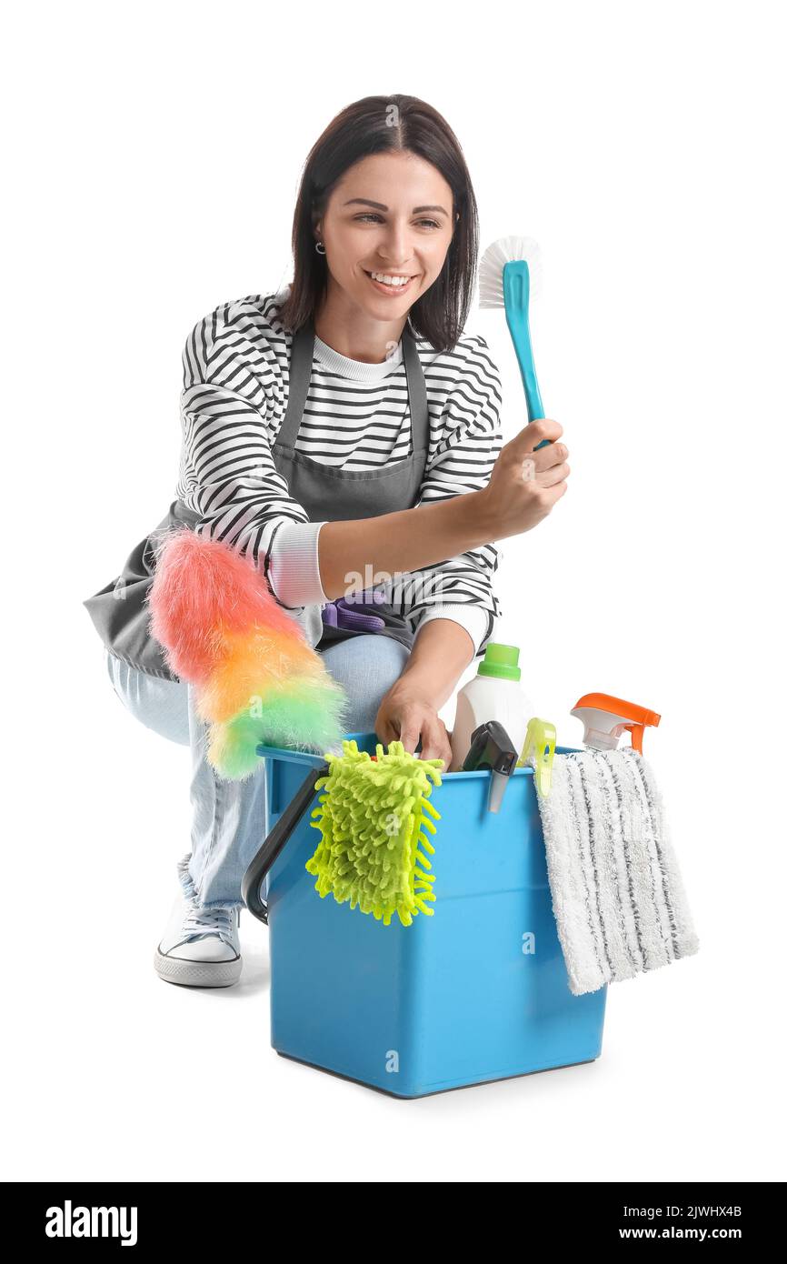 Beautiful woman and bucket with cleaning supplies on white background ...
