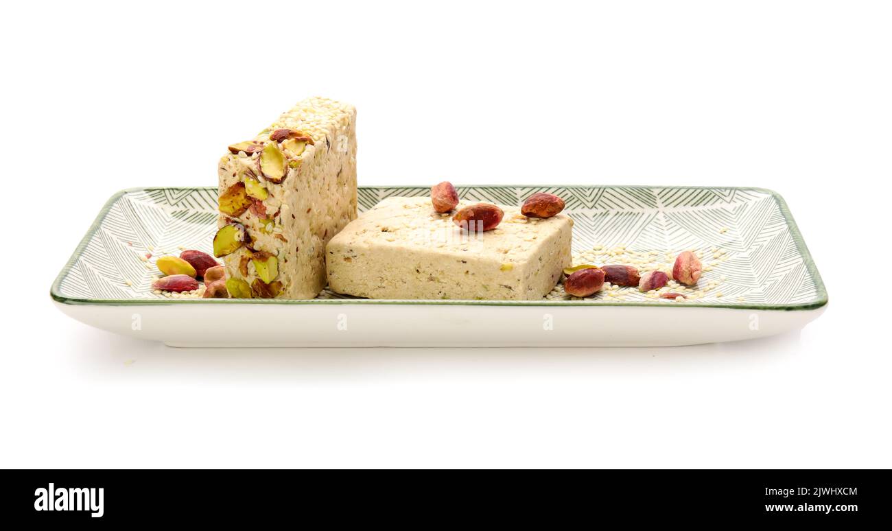 Plate of tasty sesame halva with pistachios on white background Stock Photo - Alamy