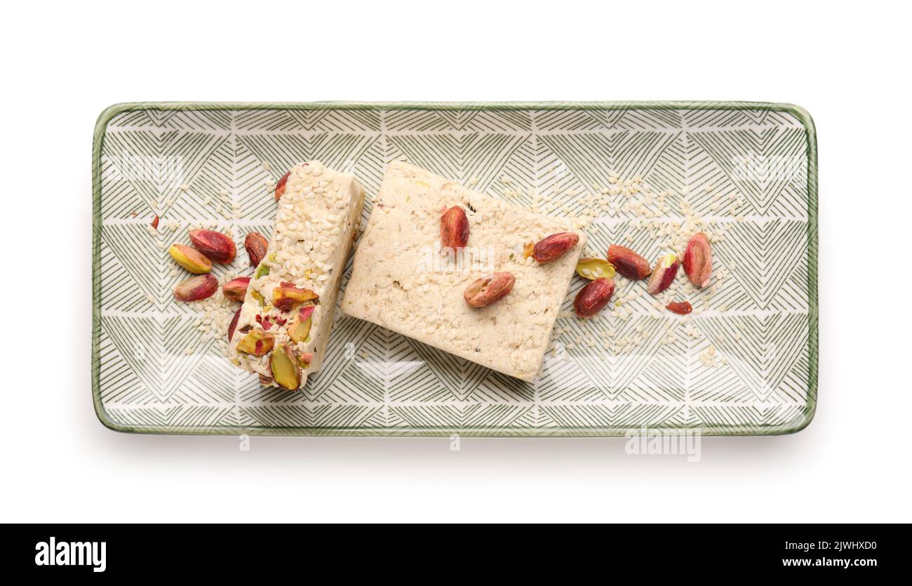 Plate of tasty sesame halva with pistachios on white background Stock Photo - Alamy