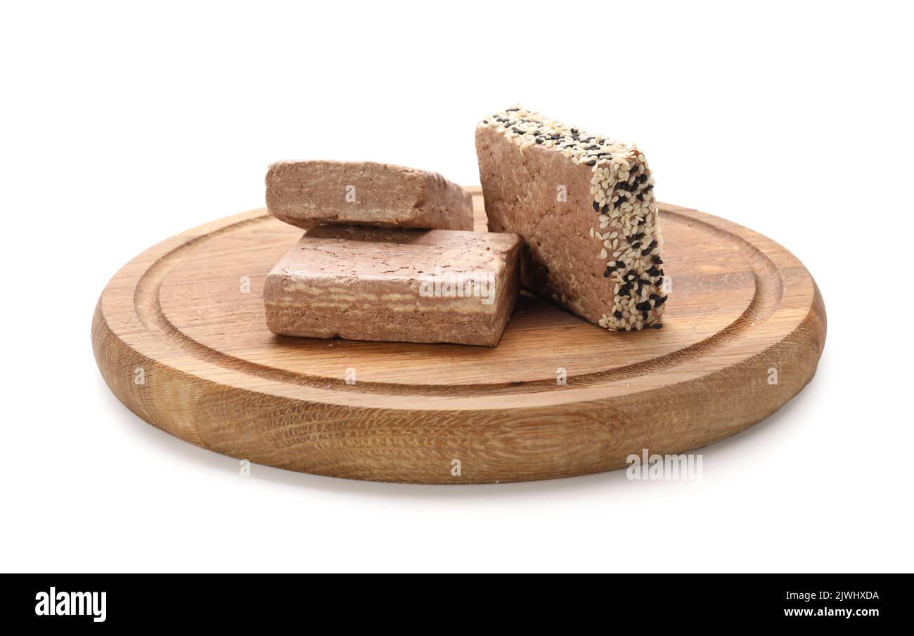 Wooden board of tasty sesame halva on white background Stock Photo - Alamy