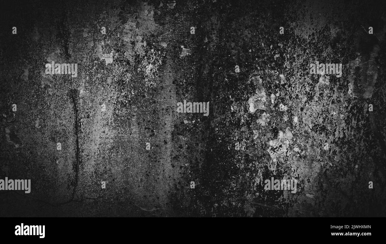 A black background with a texture of an old wall and a copy space ...