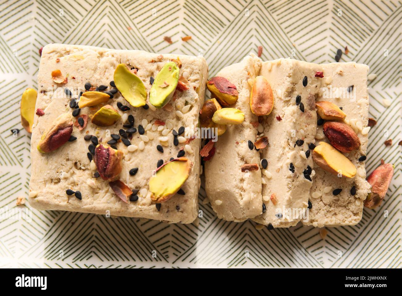 Plate of tasty sesame halva with pistachios, closeup Stock Photo - Alamy