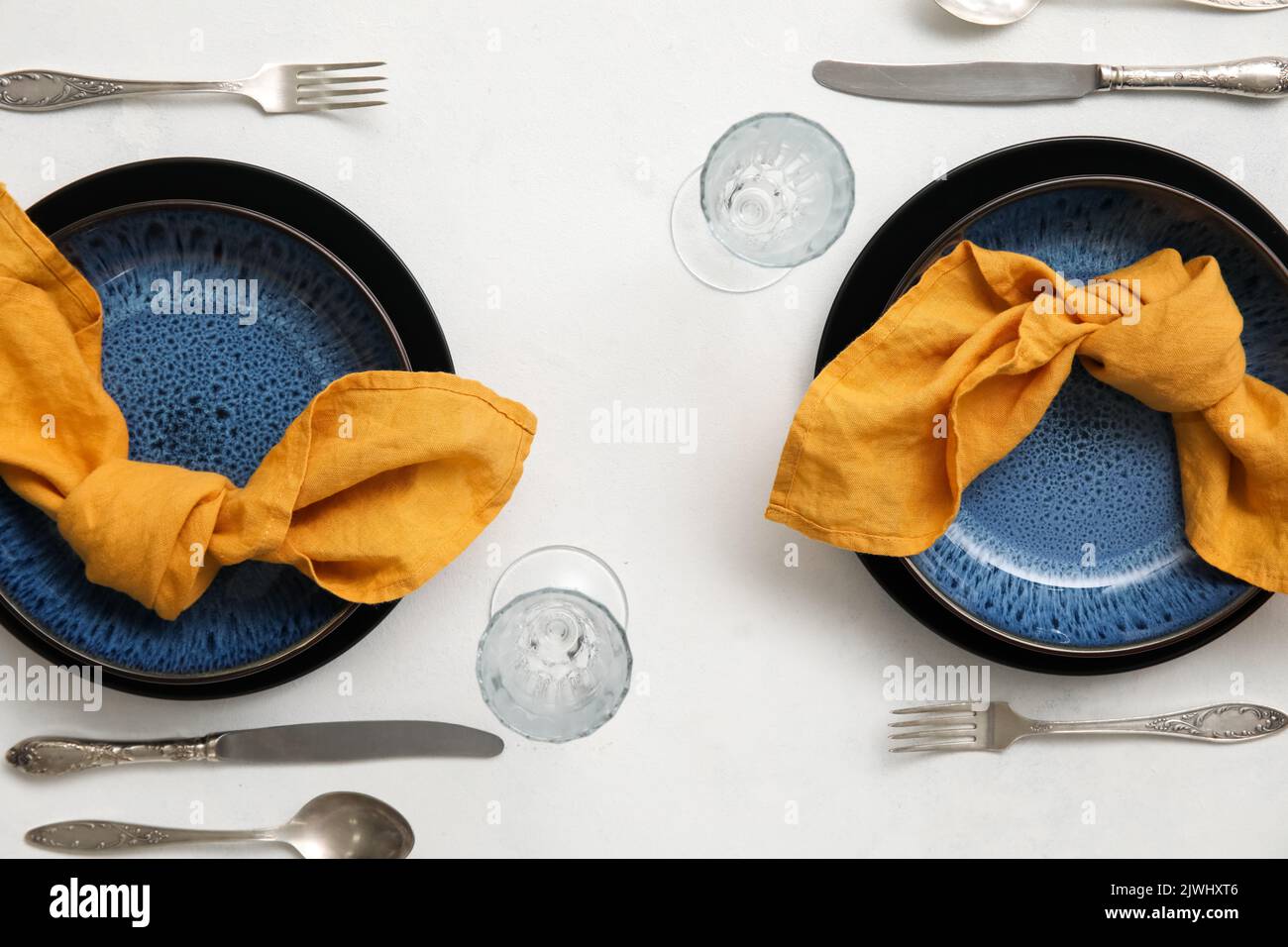 Beautiful table setting with plates, napkins and cutlery on white ...
