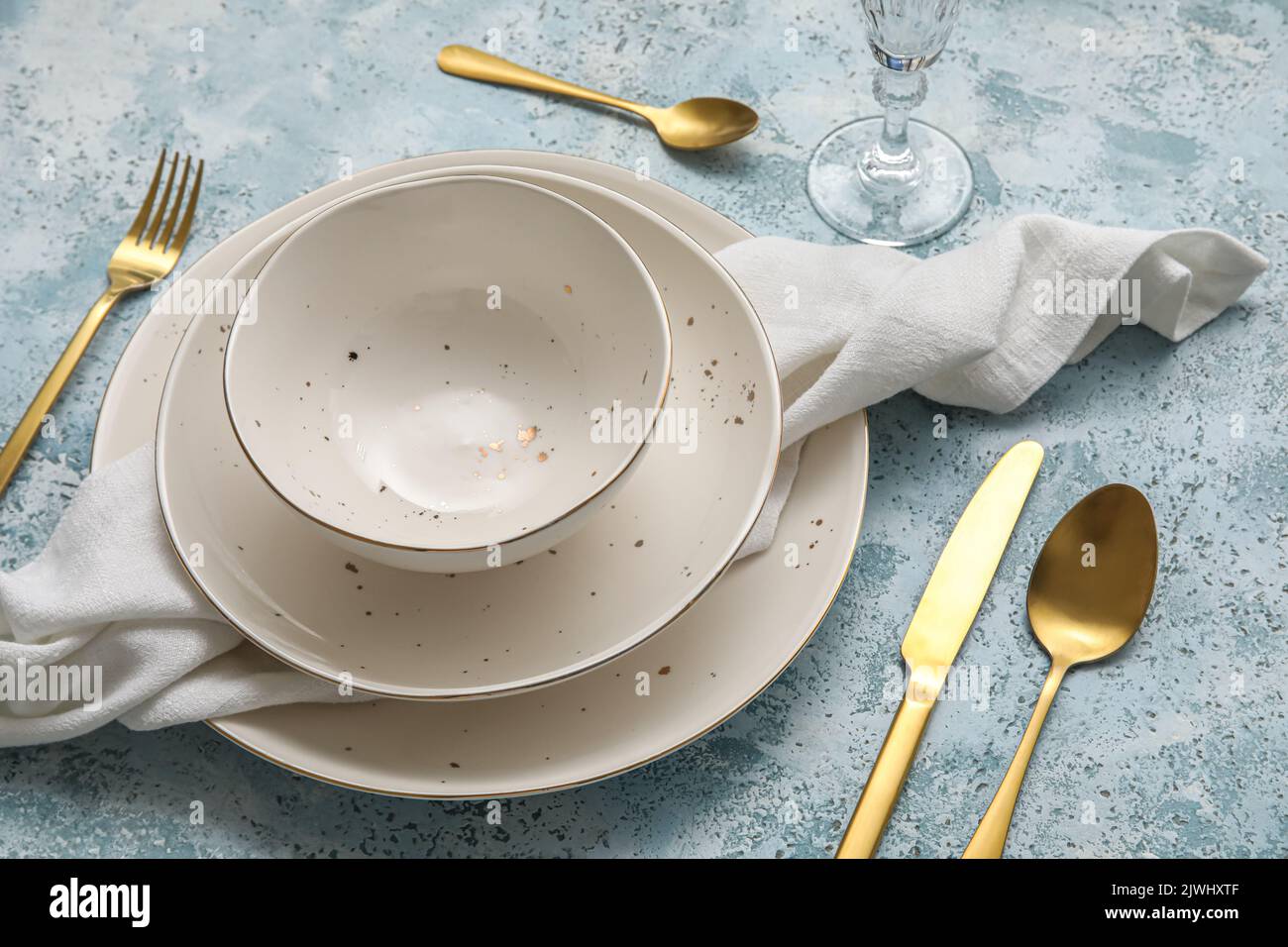 Simple dinnerware on blue table Stock Photo - Alamy