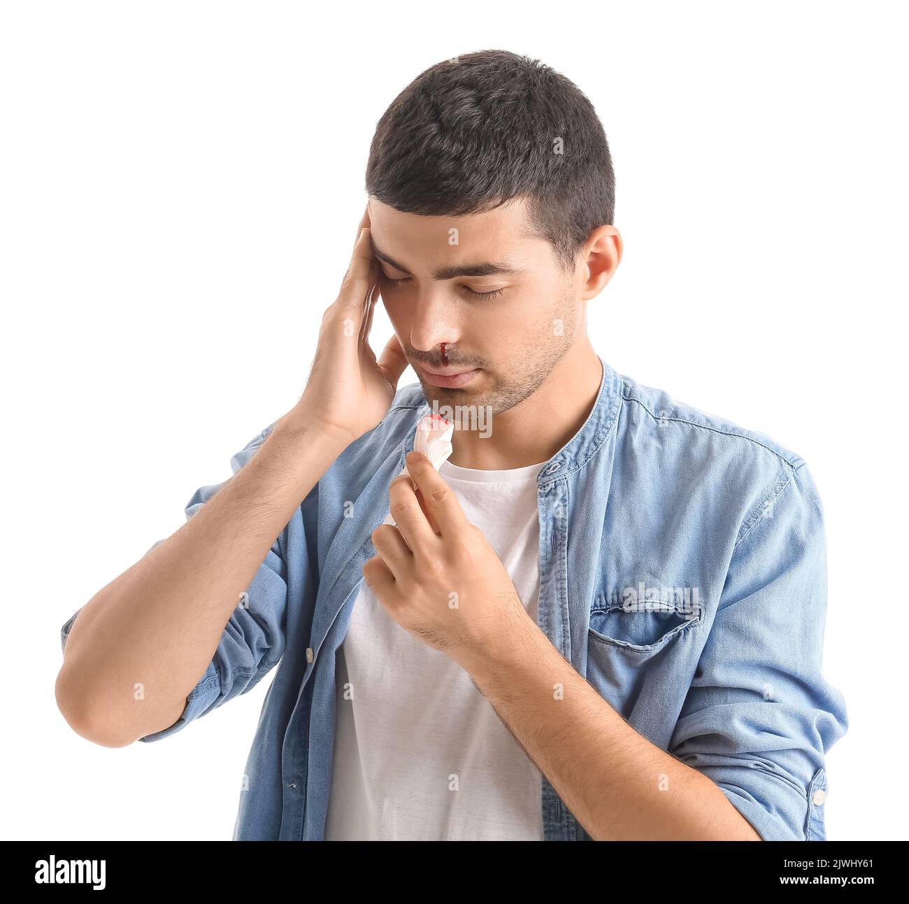 Young man with nosebleed and tissue on white background Stock Photo - Alamy