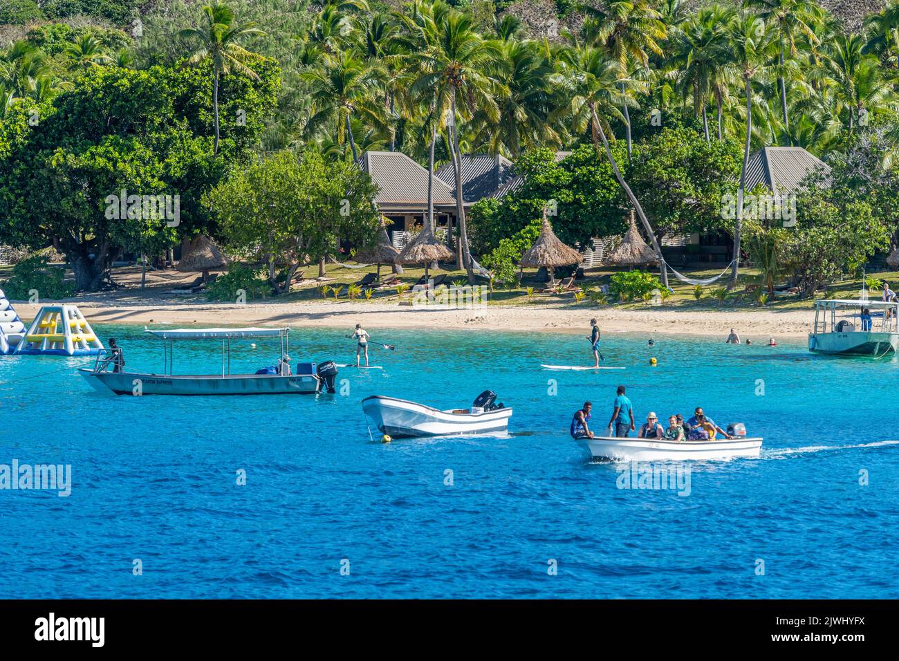 Small boats transporting guests to tourist resort, Yasawa Islands, Fiji ...