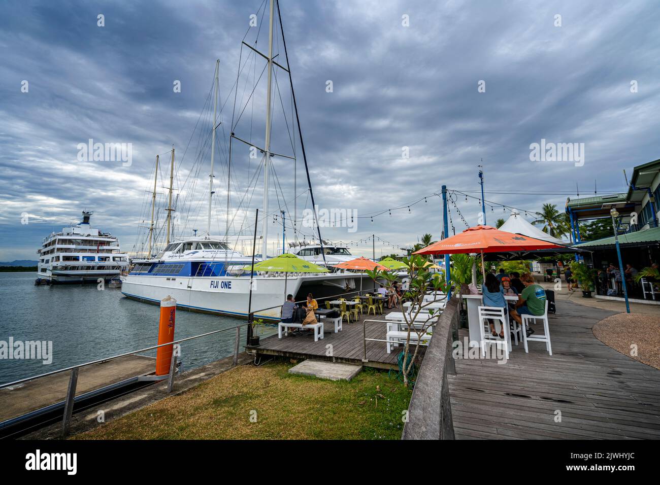 Waterside cafe with tour bouts in background, Port Denarau Marina, Nadi ...