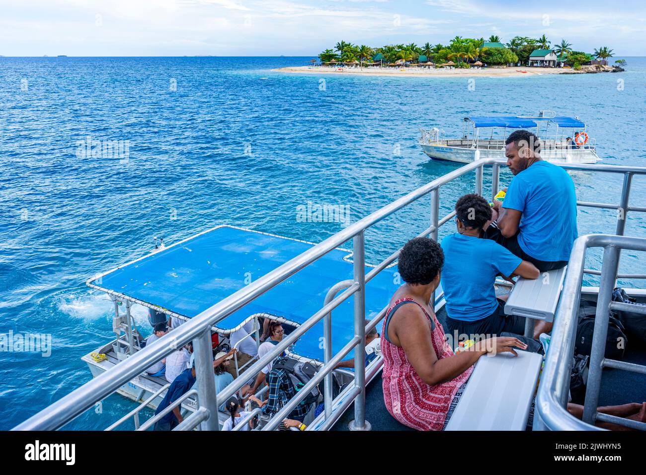 Small boats transporting tourists from Yasawa Flyer Island Ferry to ...