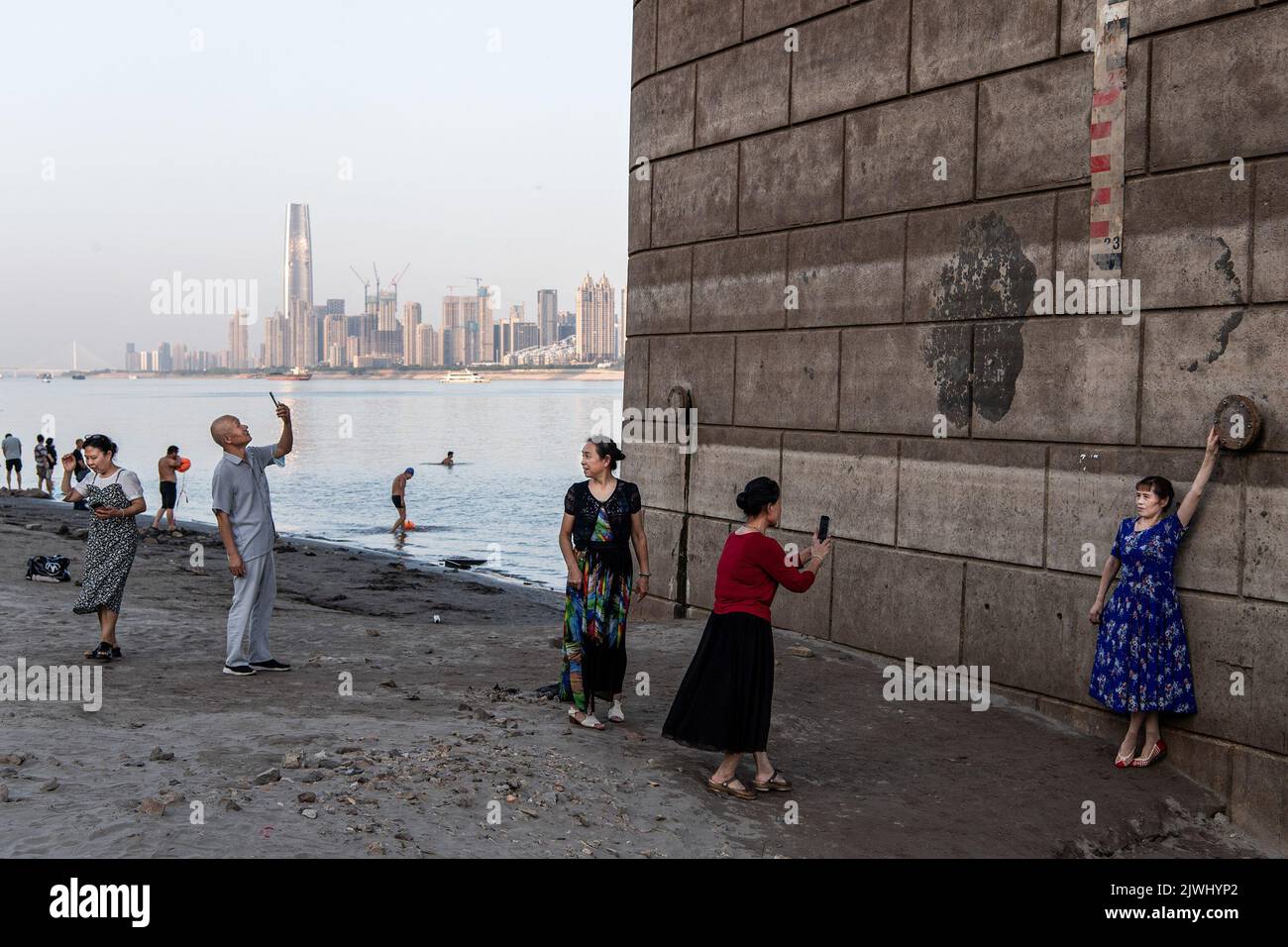Wuhan, China. 05th Sep, 2022. People take photos on the exposed pier of ...