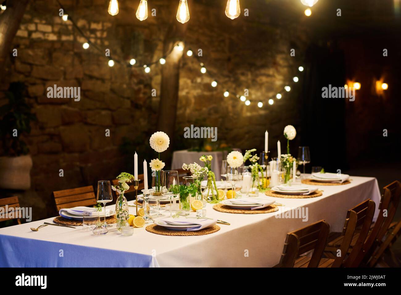 Served festive table with plates, wineglasses, decorations and napkins ...