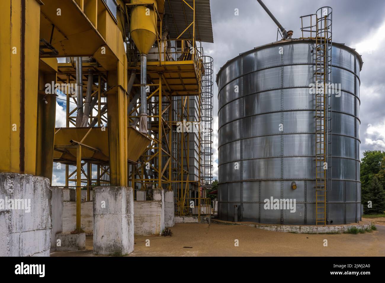 row of agro silos granary elevator with seeds cleaning line on agro ...