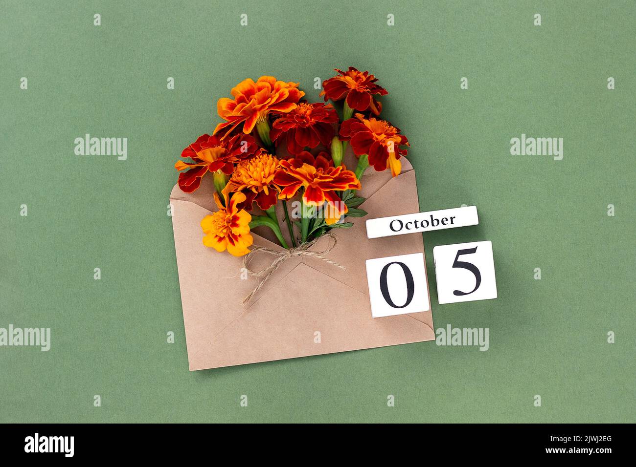 October 5. Bouquet of orange flower in craft envelope and calendar date ...