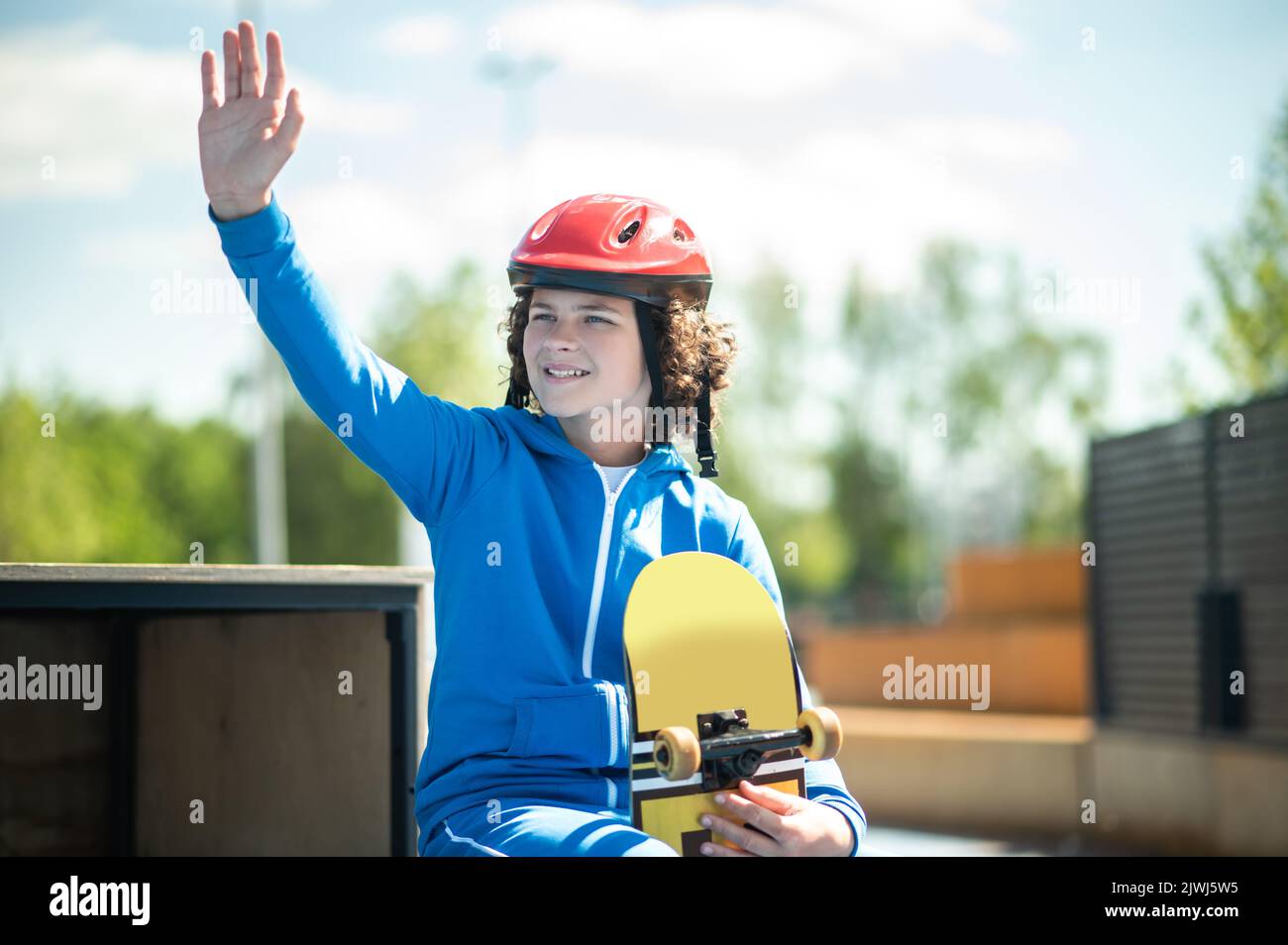 Boy waving from distance hi-res stock photography and images - Alamy