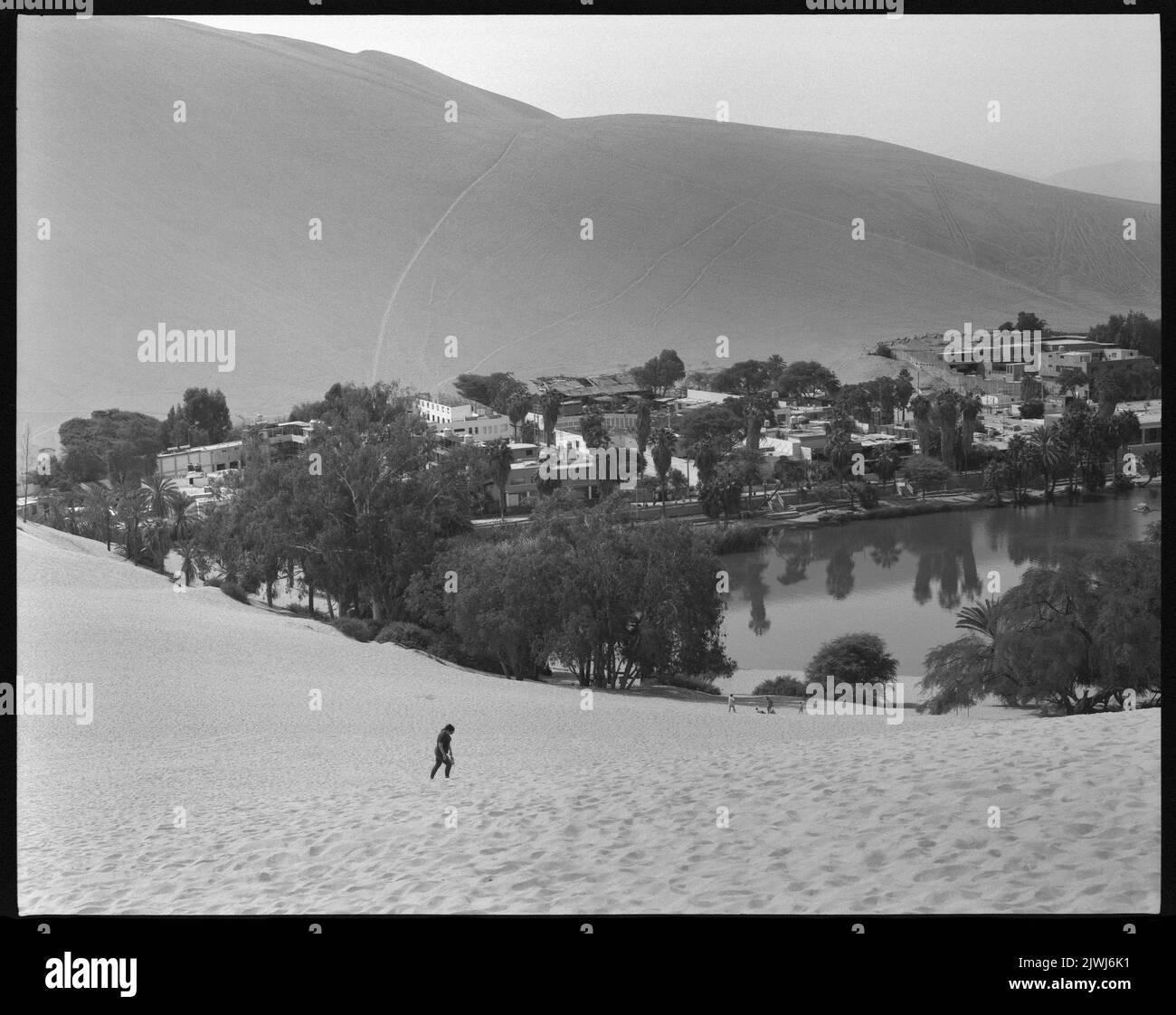 Tourist walking in sandy desert oasis, Huacachina, Inca Lima, Peru ...