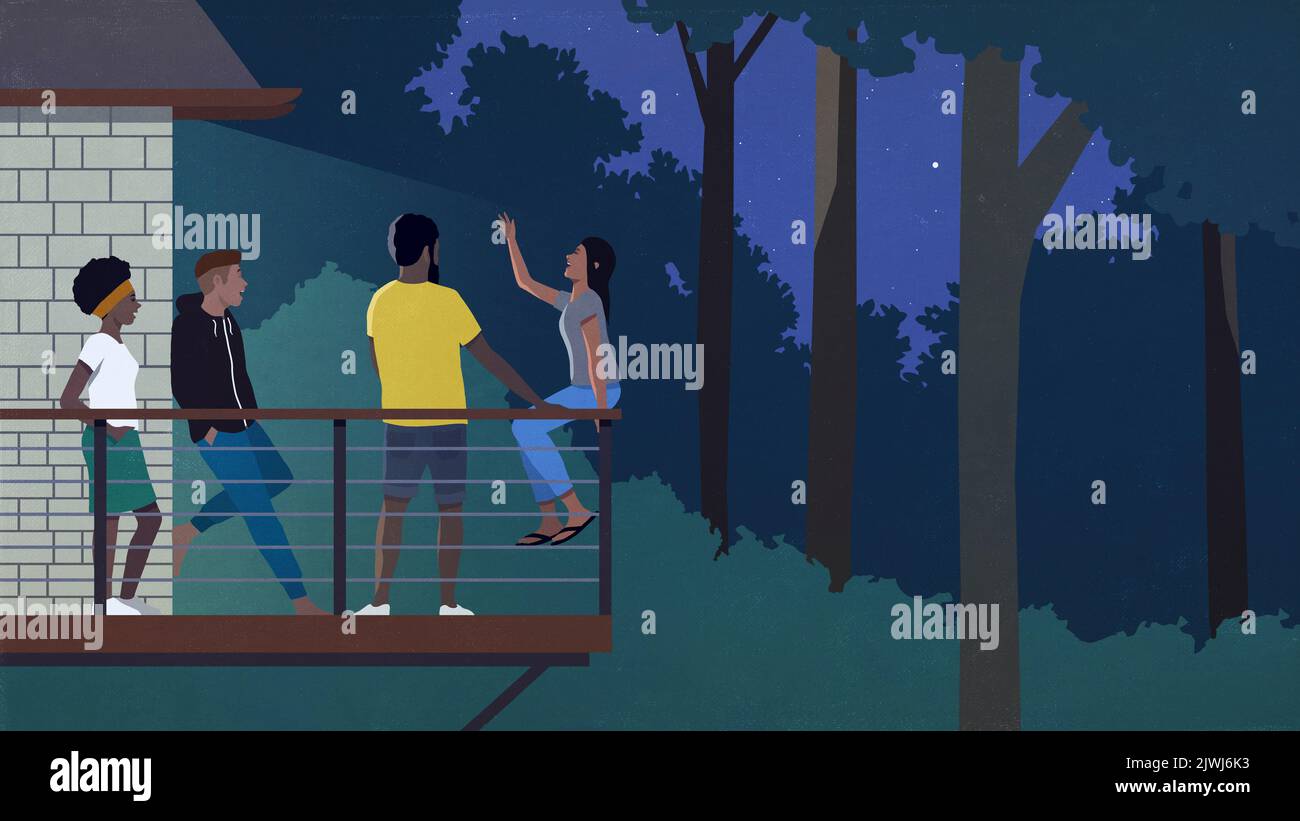 Friends talking on balcony in woods at night Stock Photo - Alamy