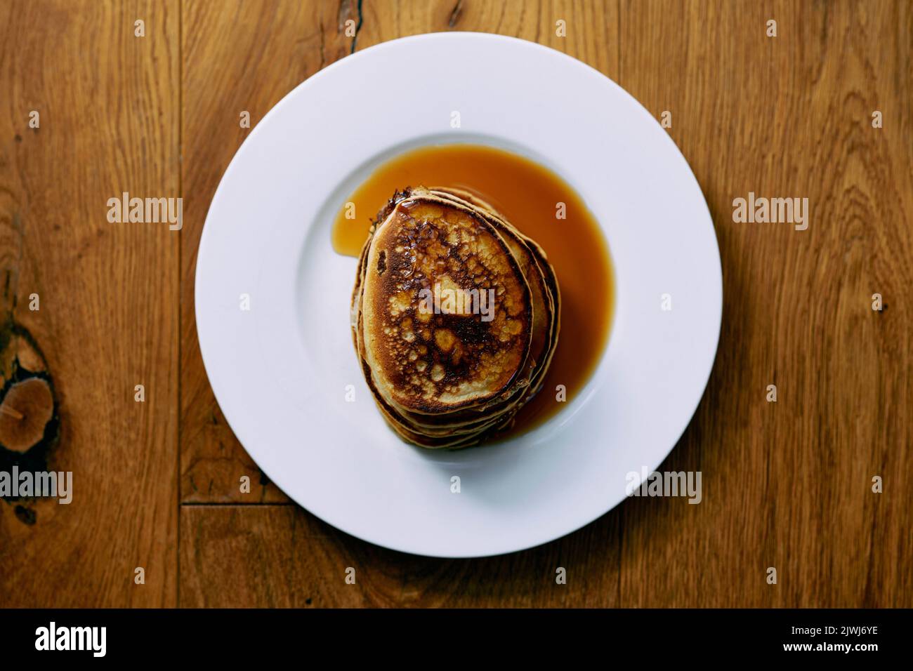 Still life stack of pancakes with maple syrup on plate Stock Photo - Alamy