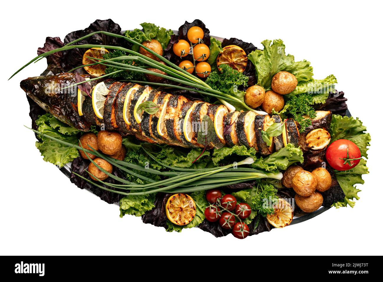 Grilled sliced fish banquet dish with vegetables Stock Photo - Alamy