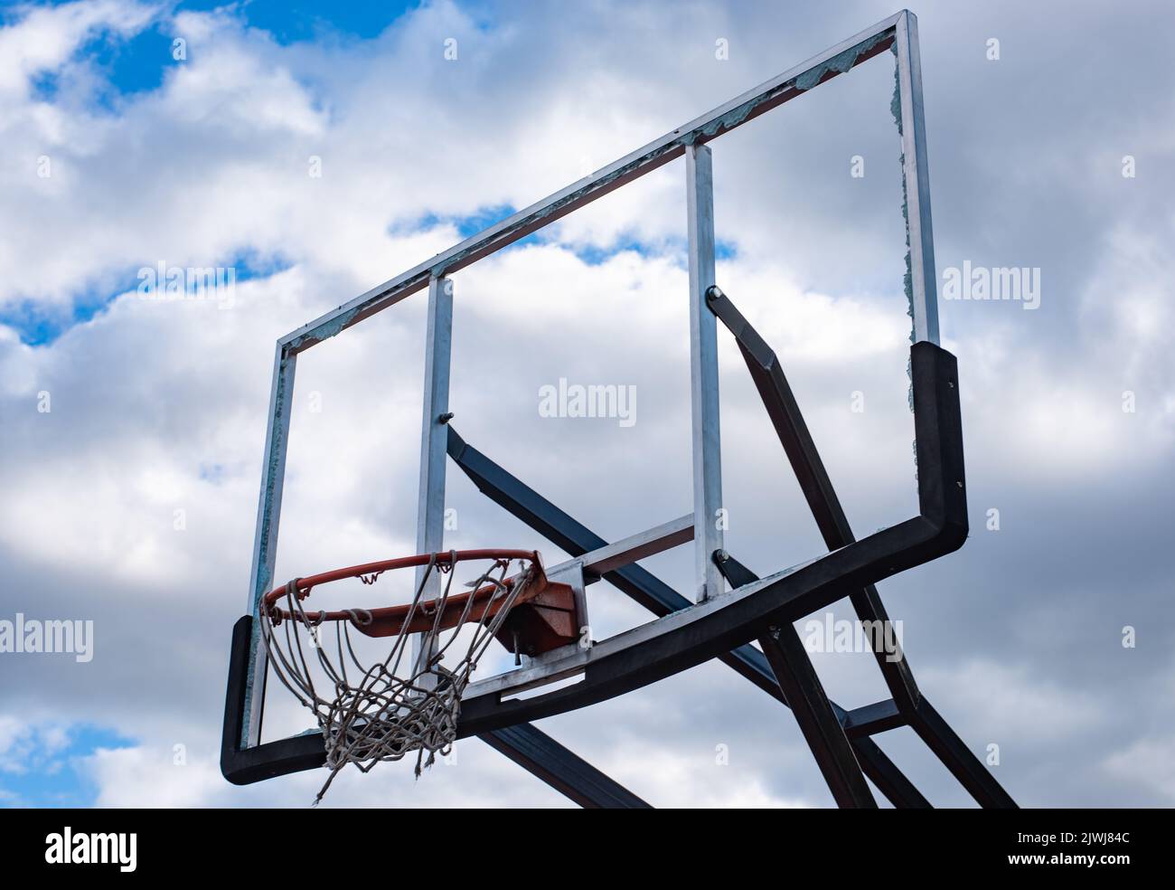 Broken glass backboard and broken hoop on the basketball court Stock ...