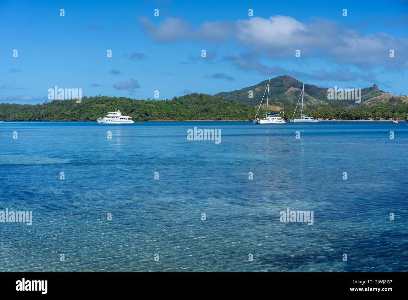 Yacht and cruisers anchored in Blue Lagoon off Nanuya Island, Yasawa ...