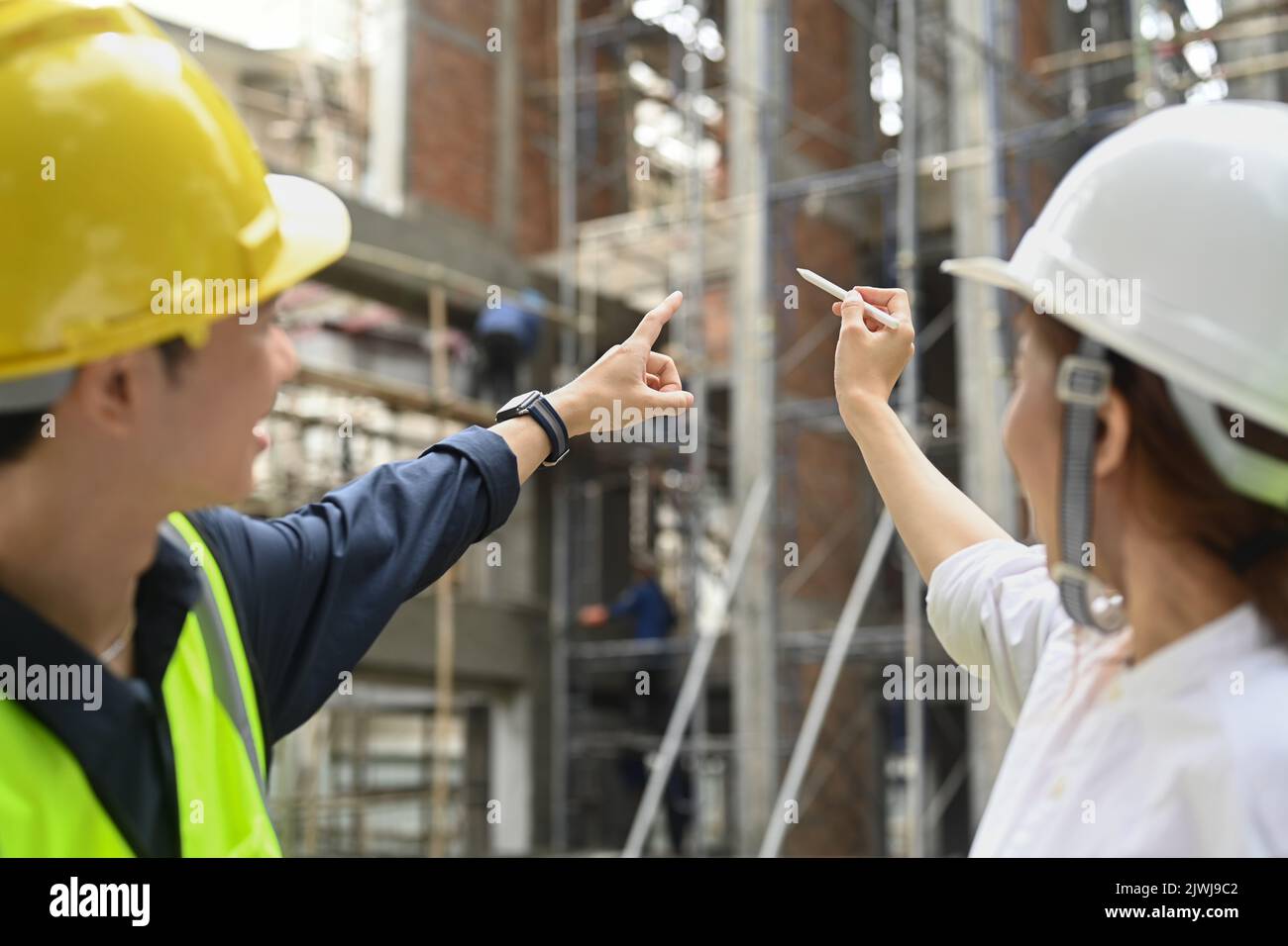Female architects and civil engineer supervising progress of ...