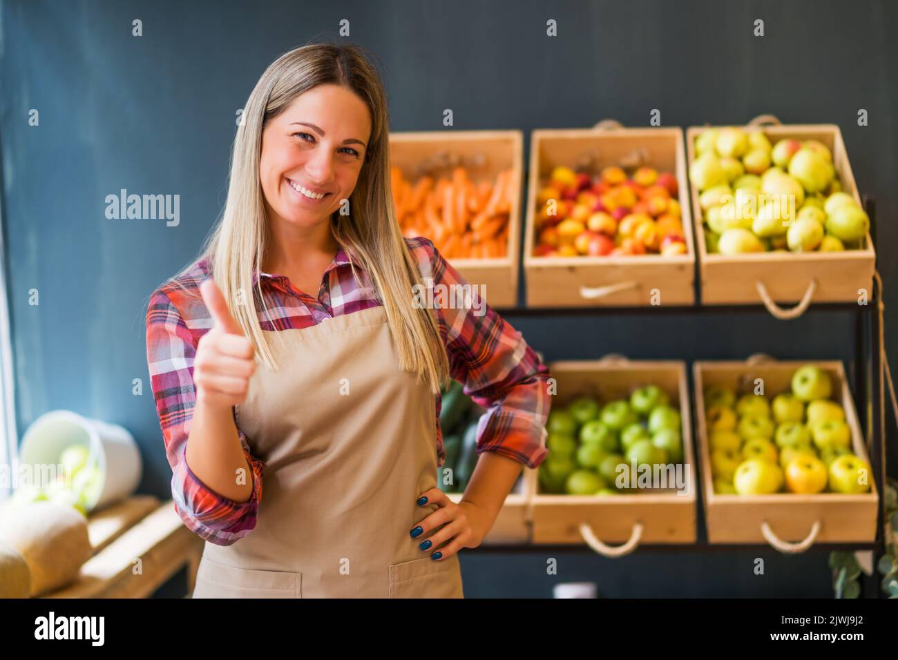 Portrait of happy food supermarket owner. Woman works in fruits and ...