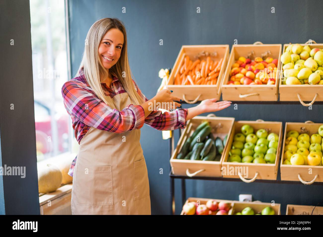 Portrait of happy food supermarket owner. Woman works in fruits and ...
