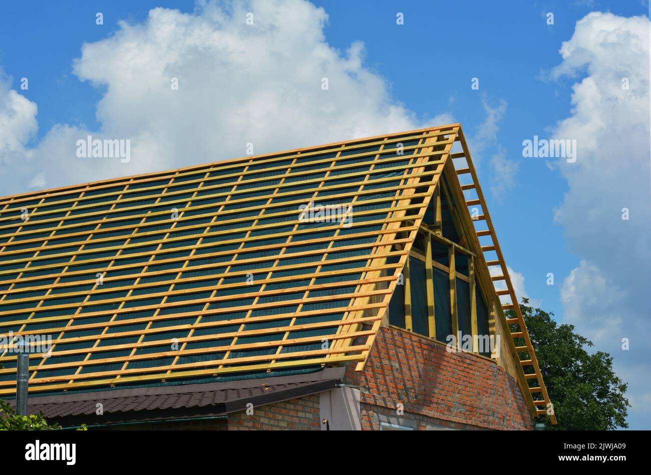 Roofing construction and renovation. A close-up of a pitched roof ...