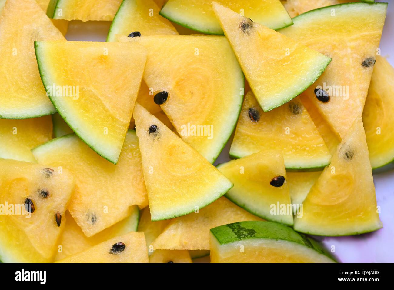 Yellow watermelon slice on background, Closeup pile of sweet watermelon ...