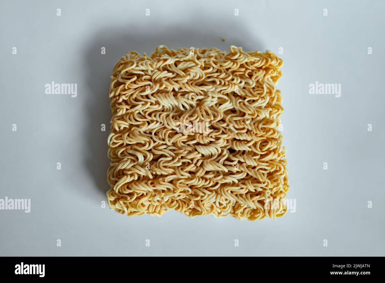 Instant noodles block on white background Stock Photo - Alamy