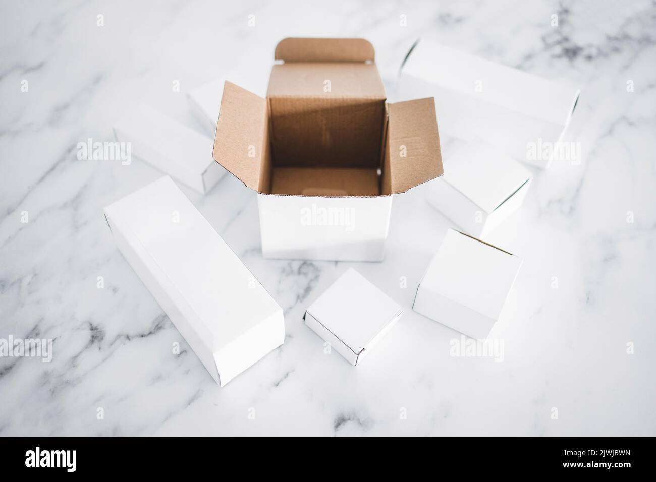 group of white plain delivery parcels with an open and empty one in the ...